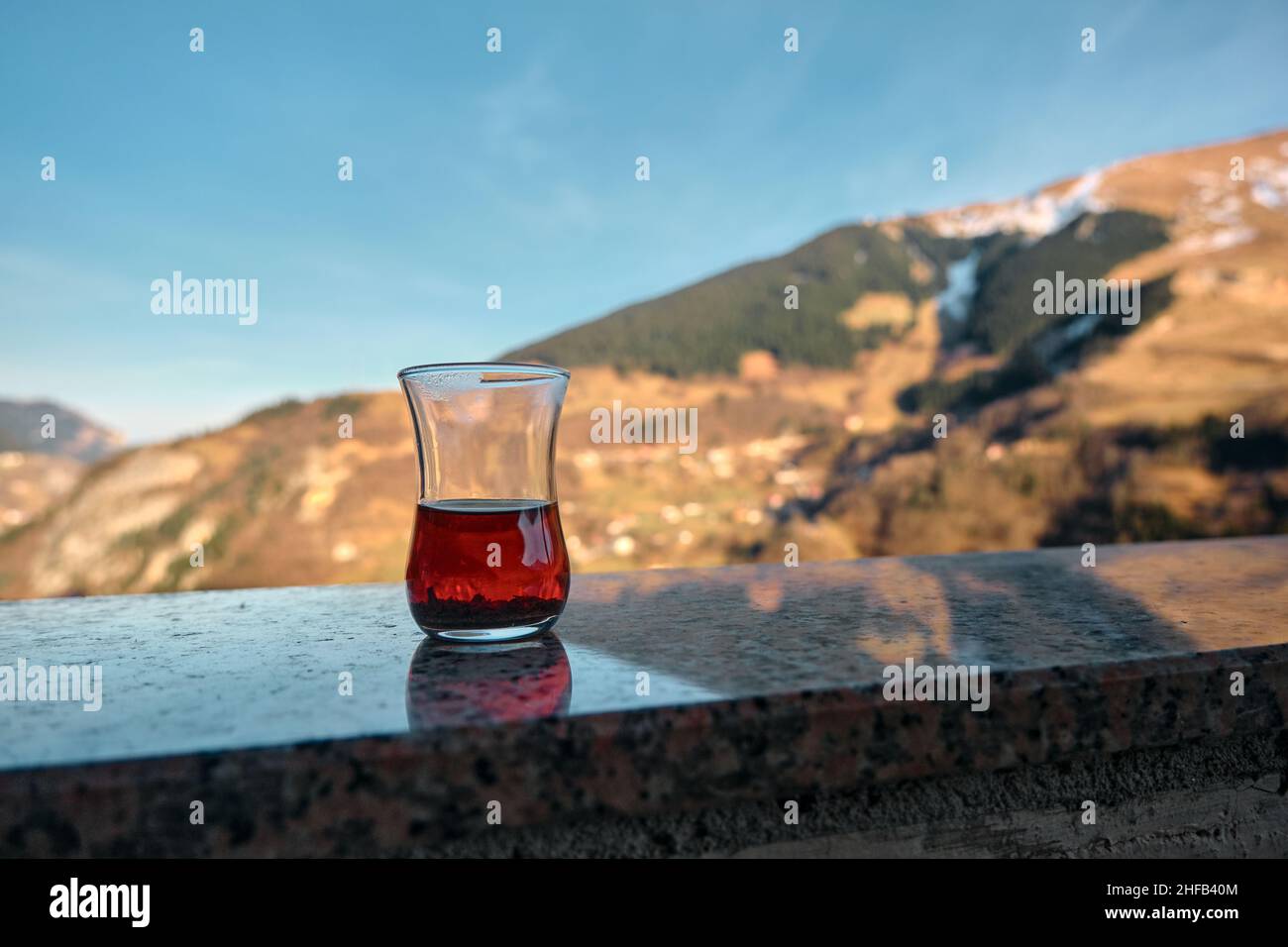 Tea and reflection on shiny surface, half filled traditional turkish ...