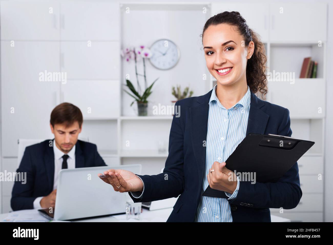Glad business female secretary having cardboard in hands Stock Photo ...