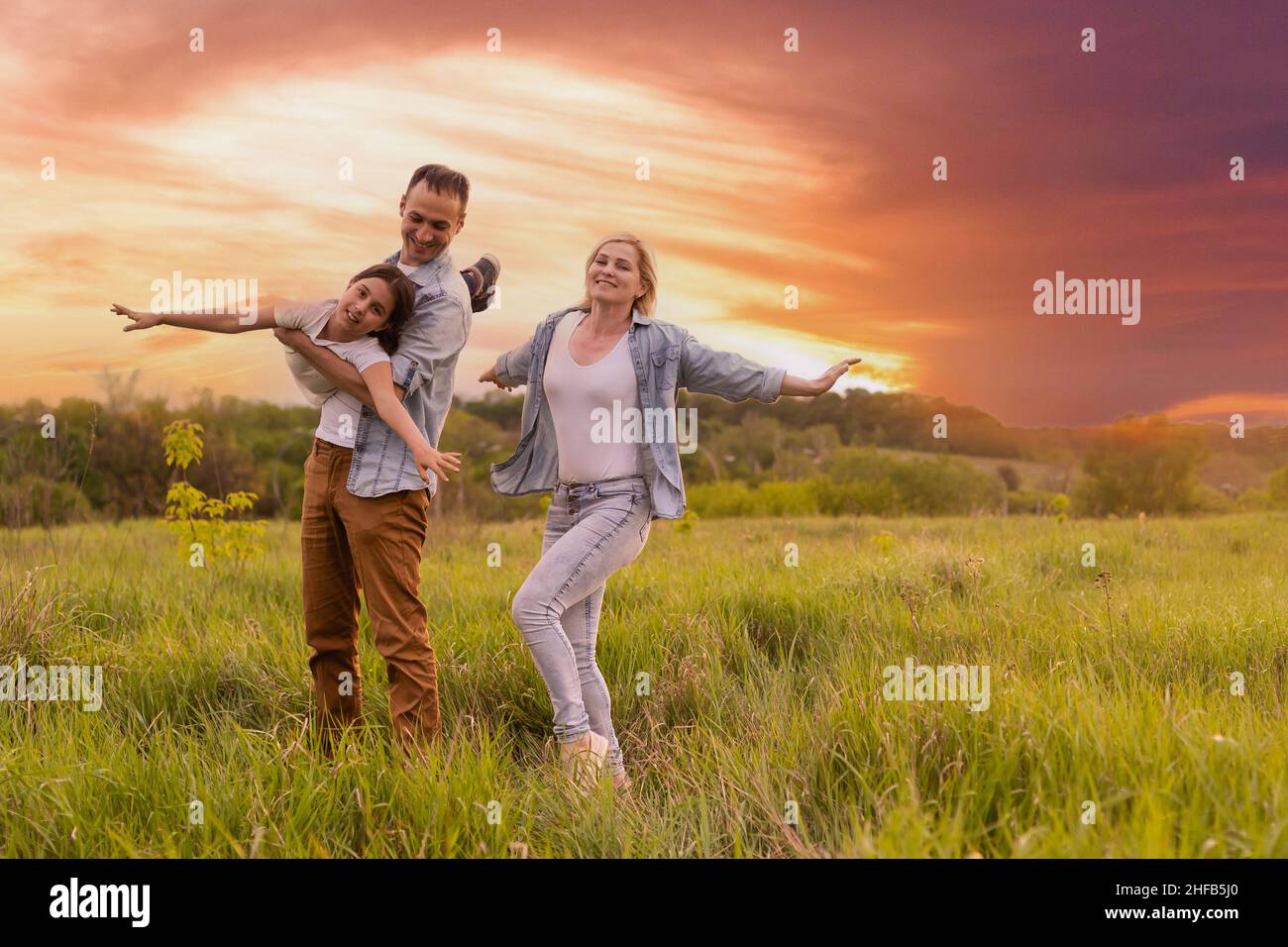 Happy family: mother father and child daughter on nature on sunset ...