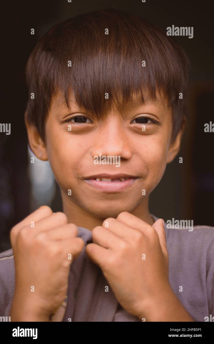 Portrait of a smiling Filipino boy from impoverished neighborhood in ...