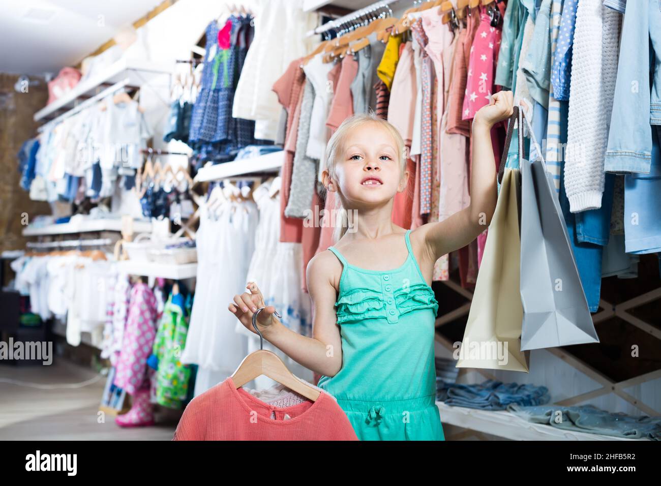 little girl in children clothes shop Stock Photo - Alamy