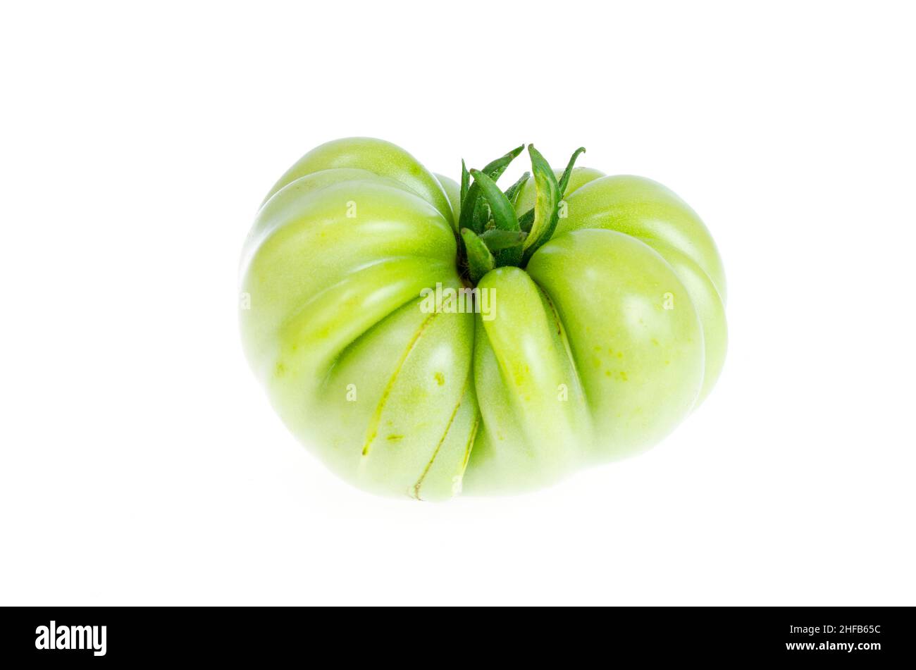 Green unripe tomato isolated on white background Stock Photo - Alamy