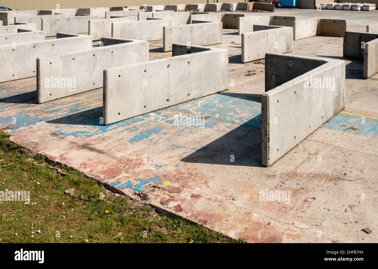 abstract geometric rows of L shaped cast concrete sections in harbour ...