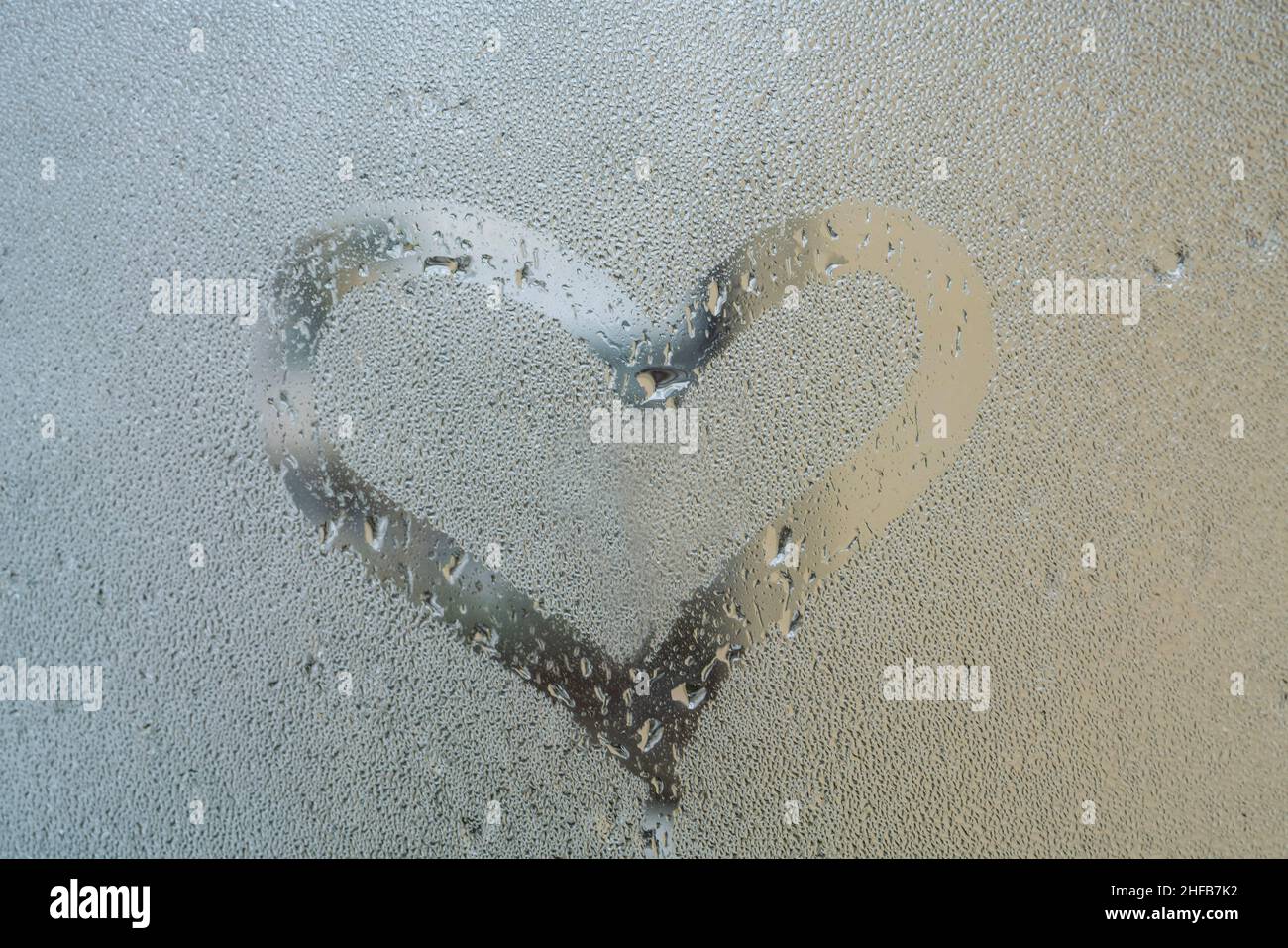 heart, hand drawn heart shape on steamed glass surface or window with ...
