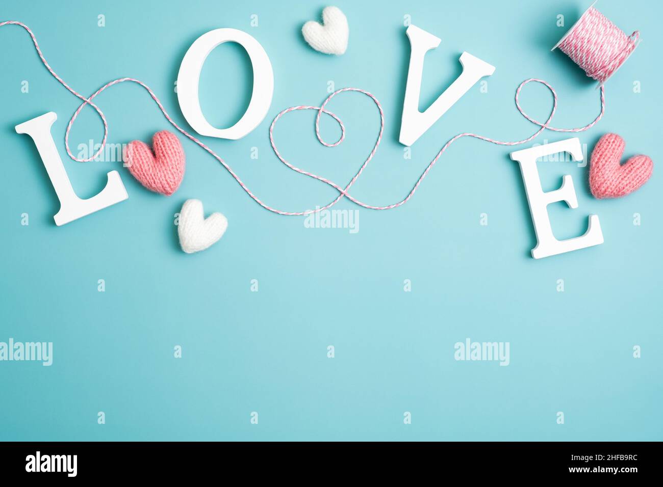 Word Love, ribbon in shape of heart, hearts on blue background. Happy ...