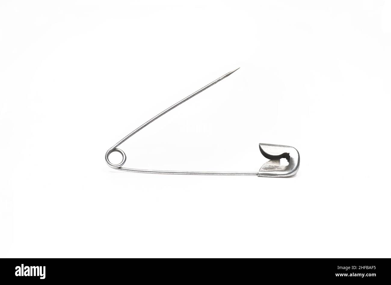 Close up of opened safety pin on white background Stock Photo - Alamy
