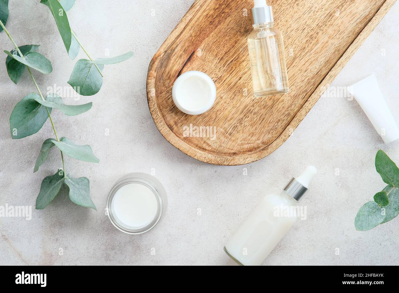 Natural skin care cosmetics and eucalyptus leaves on stone table. SPA ...