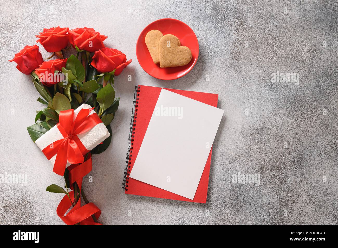 Valentine's day card with romantic gift, red roses and heart shaped ...