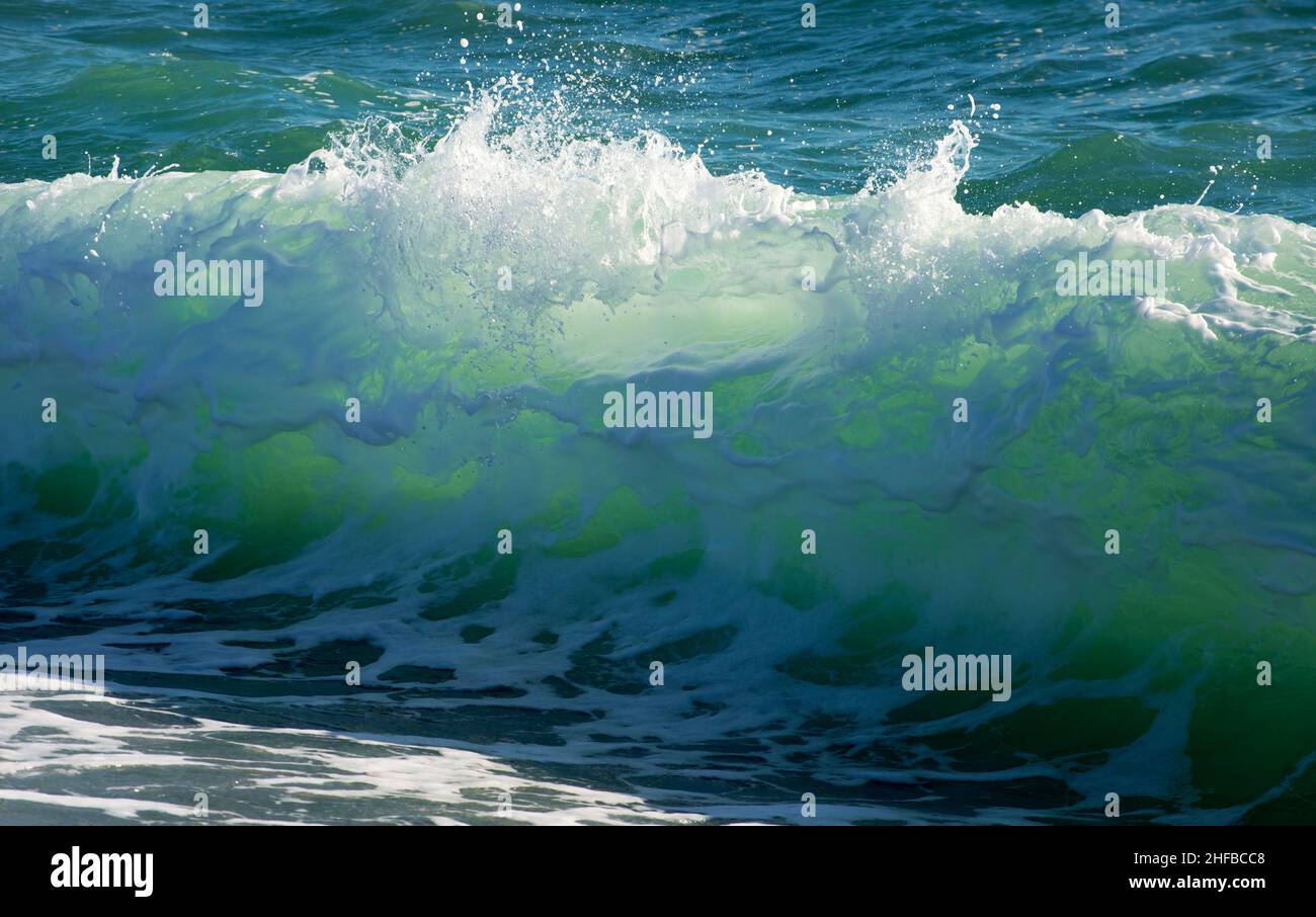 Blue wave breaking on a beach in sea Stock Photo - Alamy
