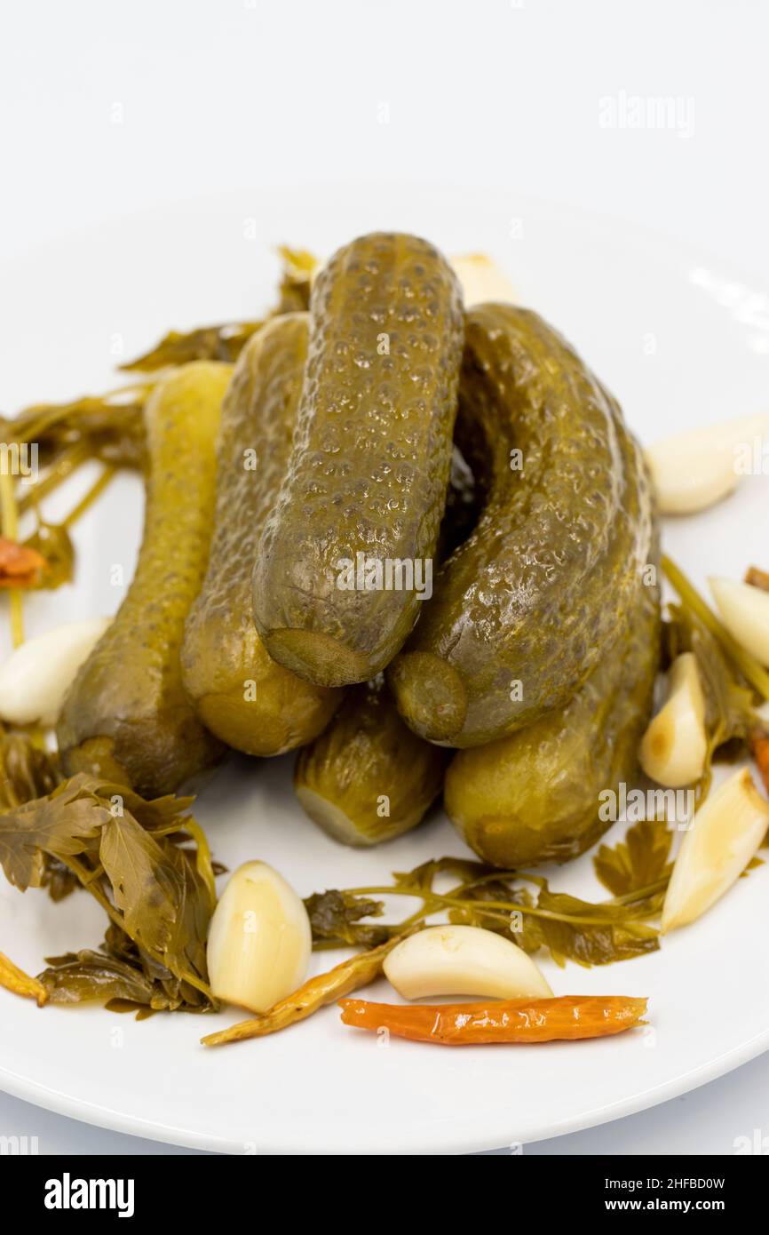 Pickled cucumbers on a white background. Close-up of pickled cucumbers ...