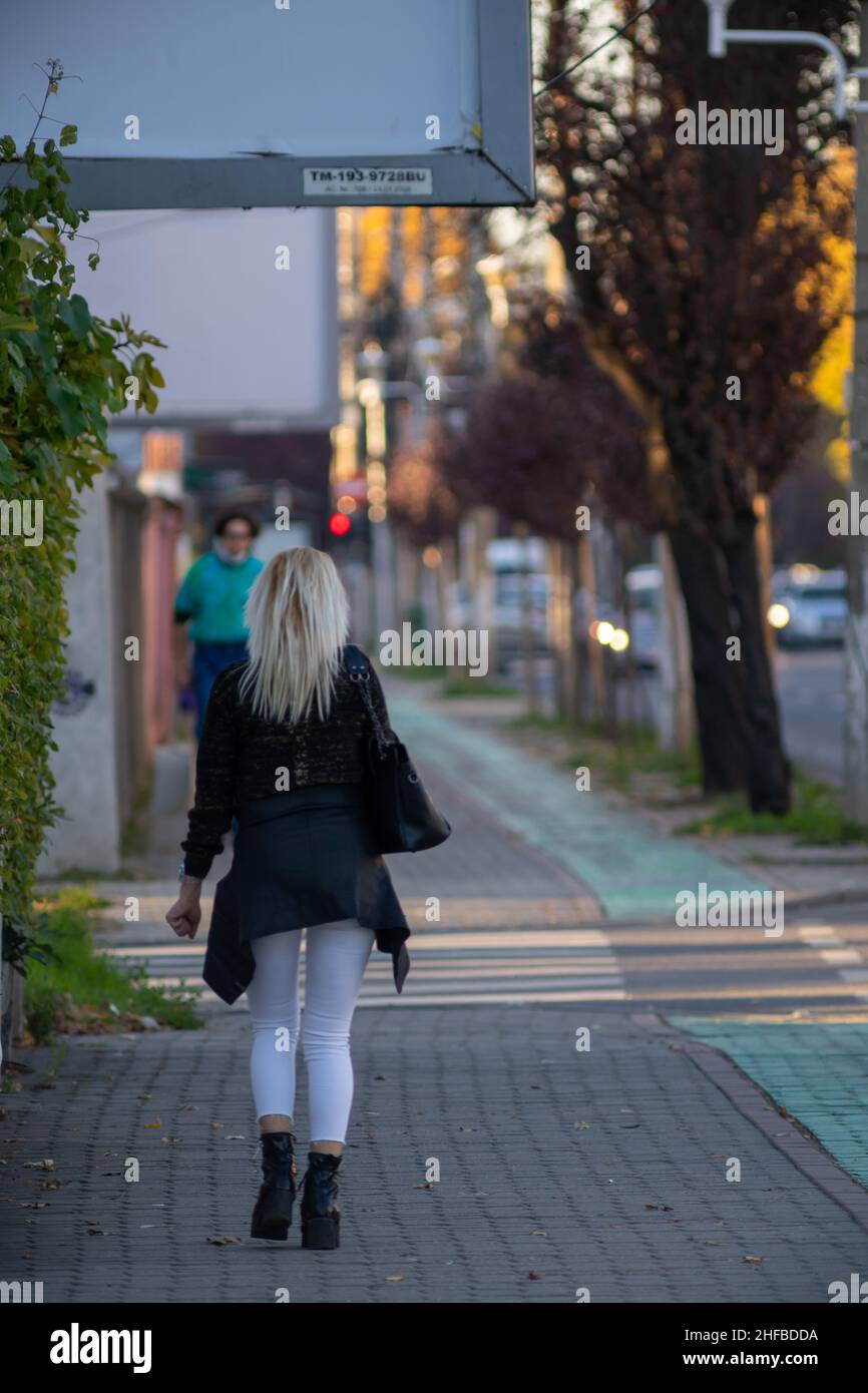 Woman walking on the street. Real people Stock Photo - Alamy