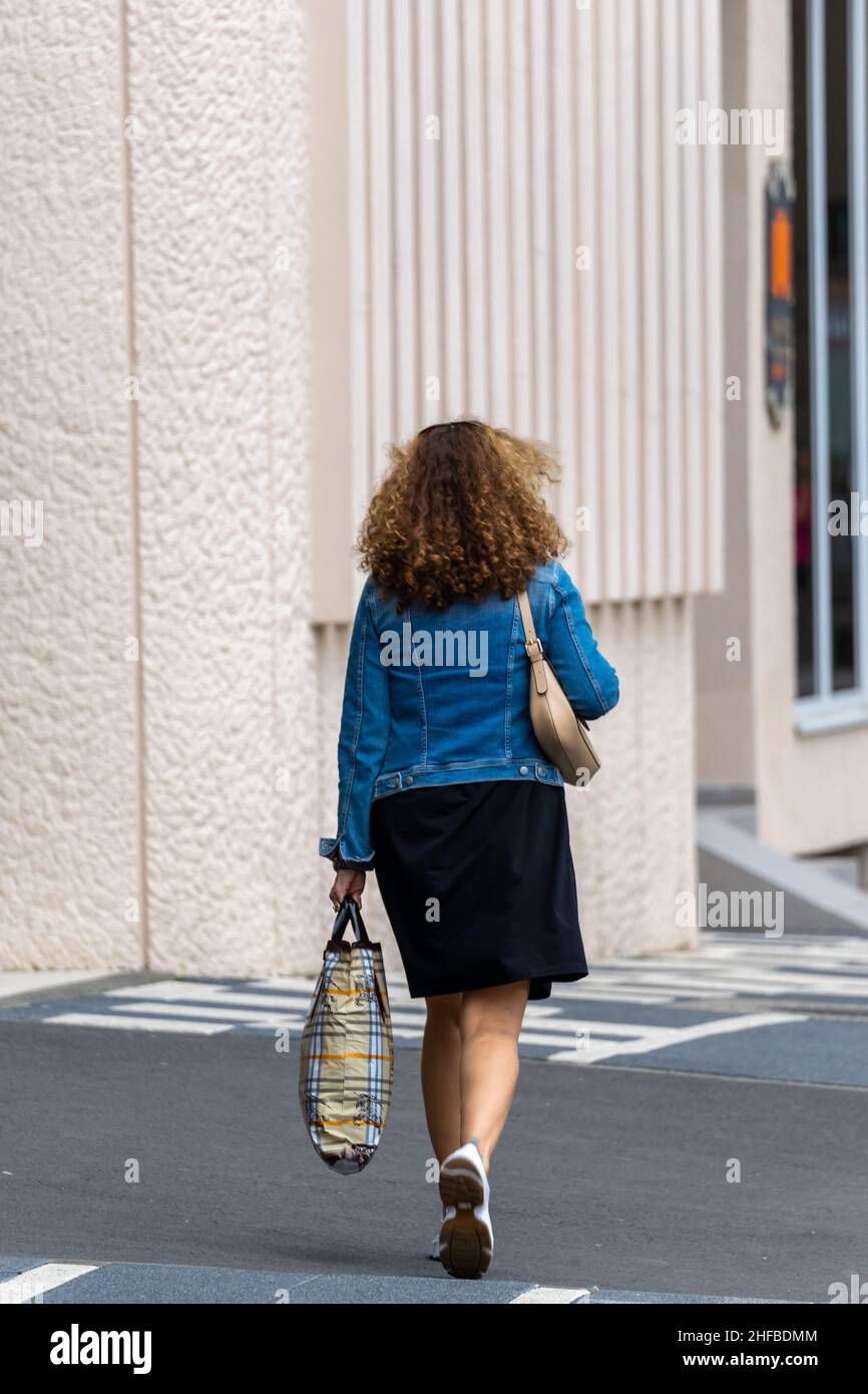 Woman walking on the street. Real people Stock Photo - Alamy