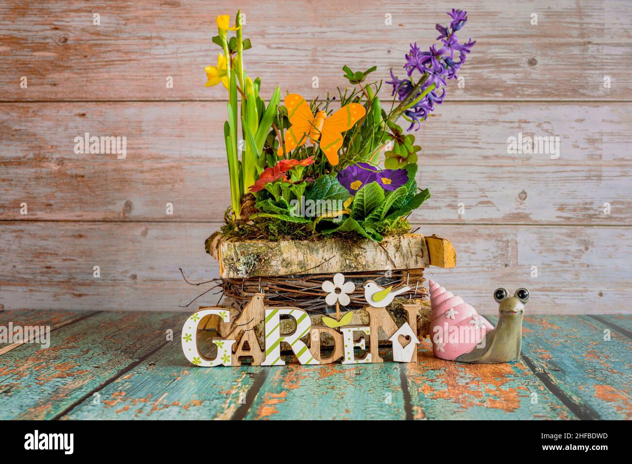 Pretty arrangement of different spring flowers with decoration on a ...