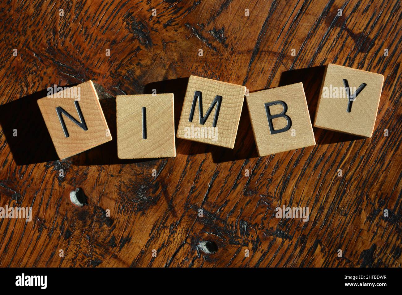 NIMBY, acronym for Not in My Back Yard, in wooden alphabet letters ...