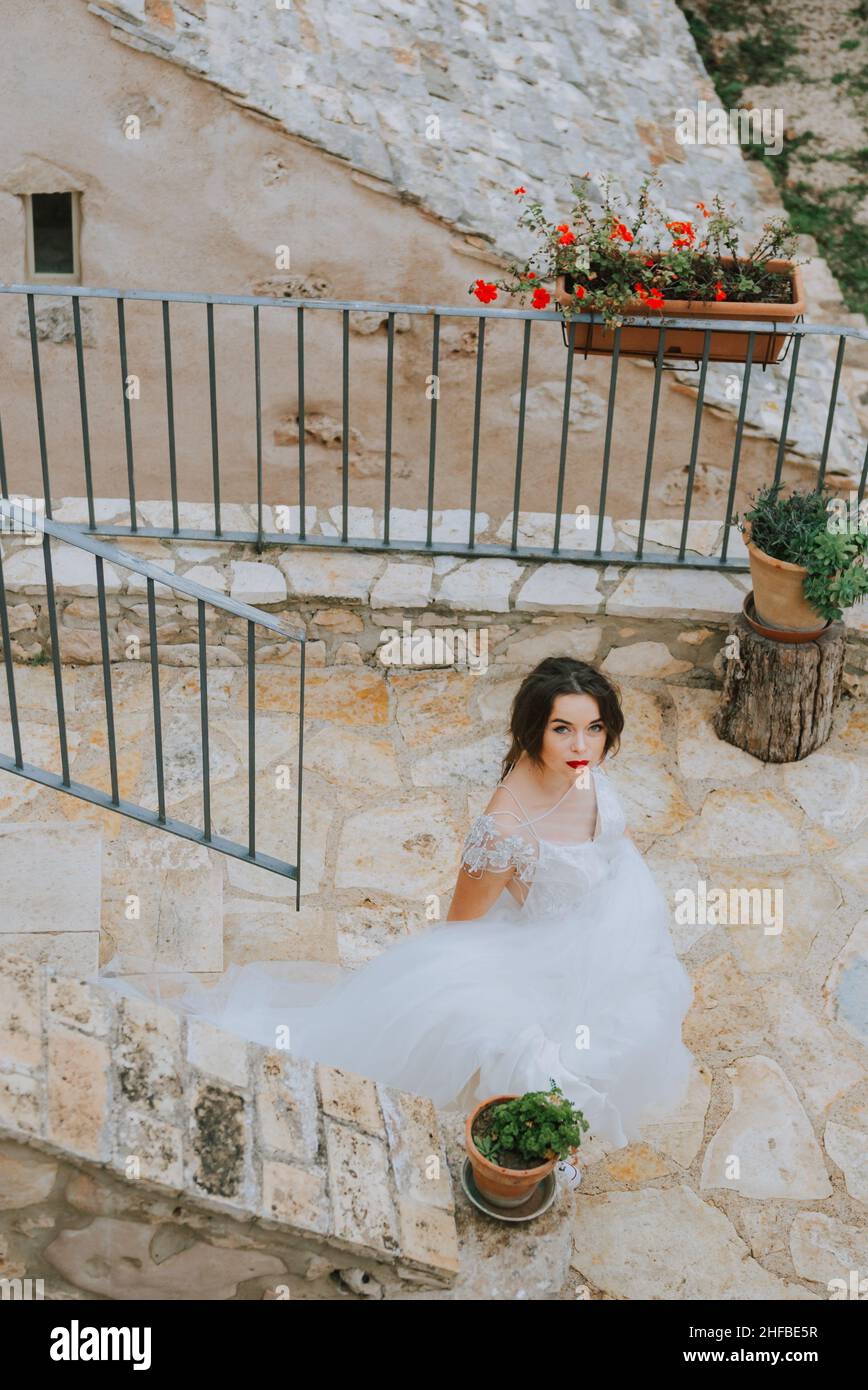 bridal female walking at ancient castle; beautiful stylish bride in ...