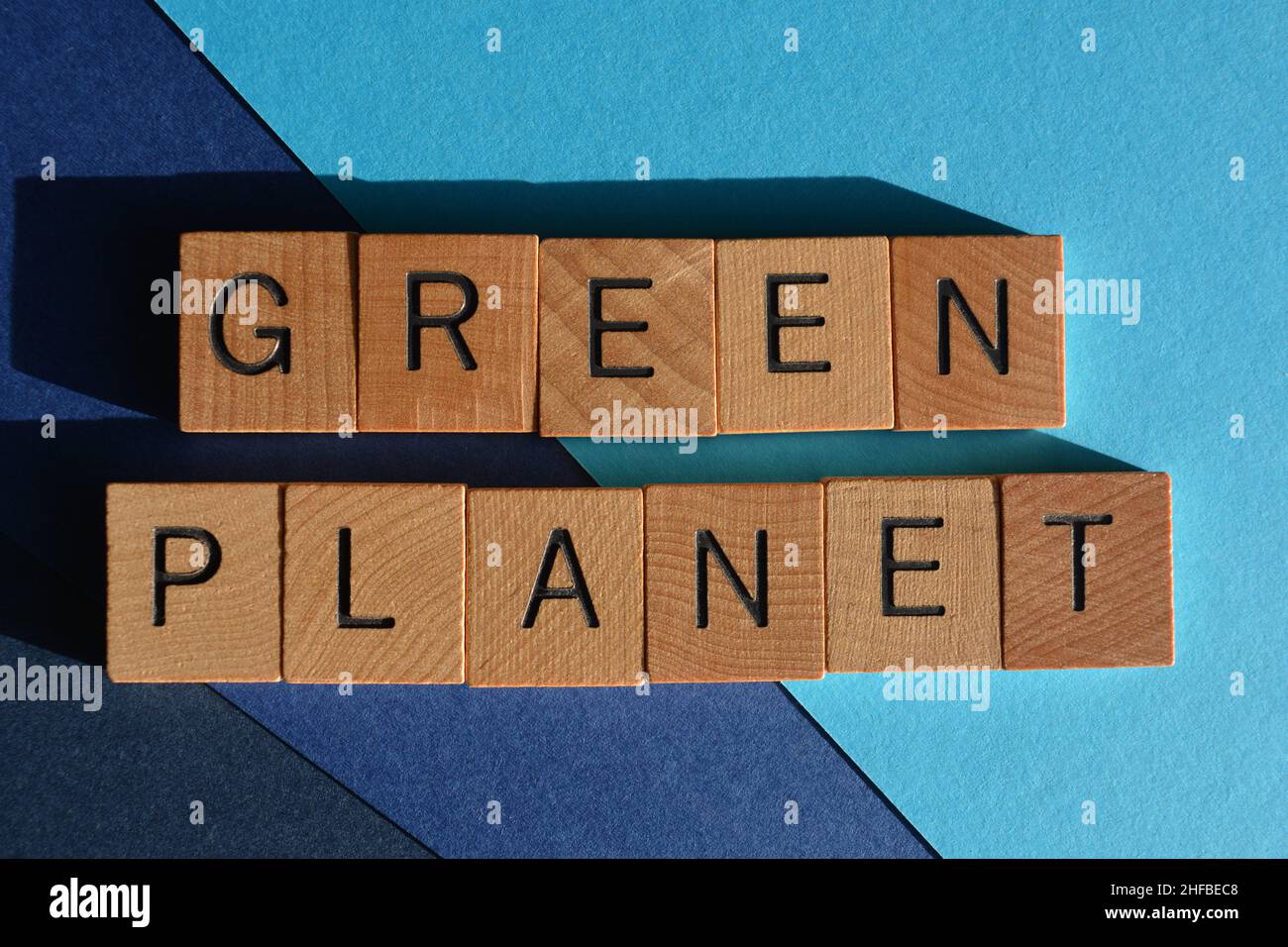 Green Planet, words in wooden alphabet letters isolated on blue ...