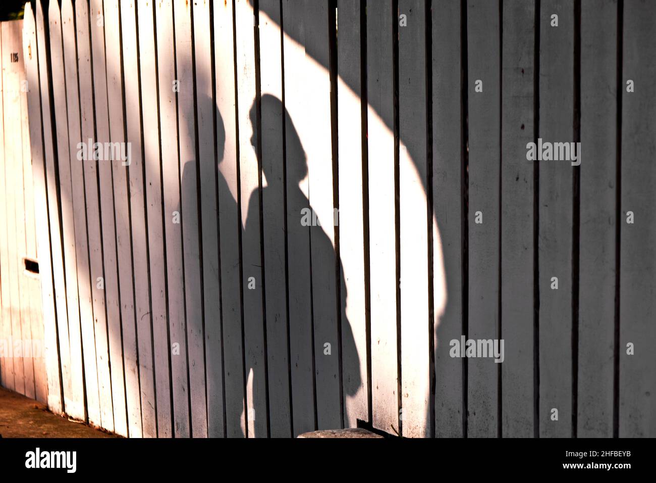 shadow of a boy with mother at a wooden fence Stock Photo - Alamy