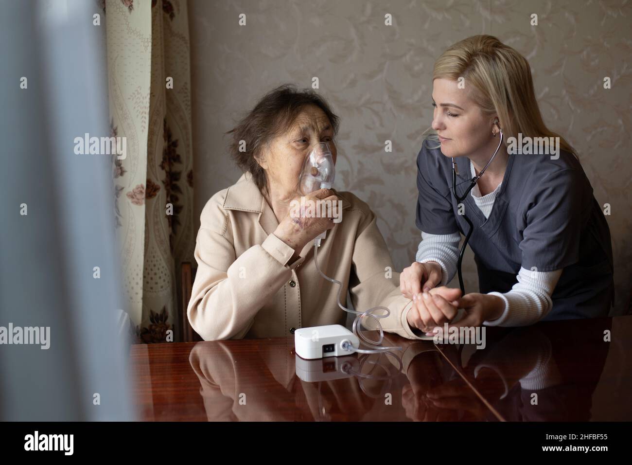 very old woman and nebulizer. Woman making inhalation Stock Photo - Alamy