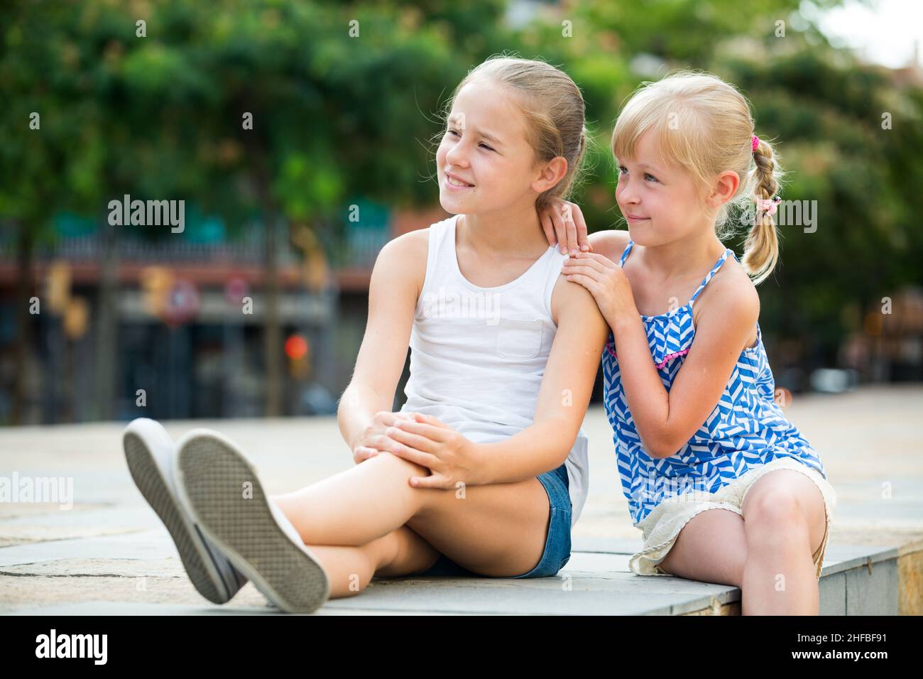 Two girls looking into distance outdoors Stock Photo - Alamy