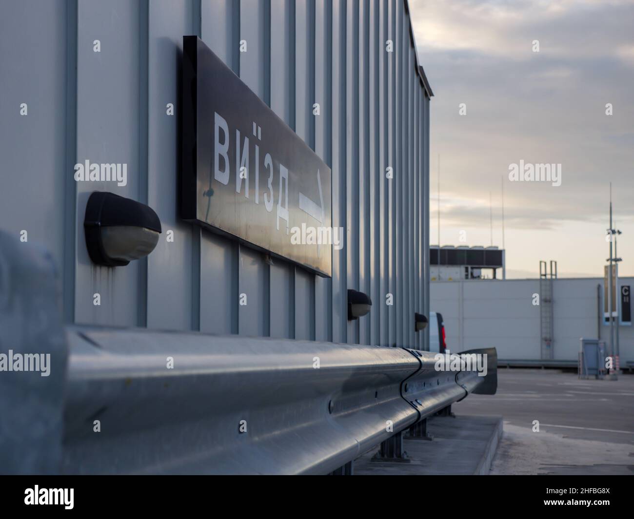 Directional exit right arrow sign in black and white on the metal wall ...