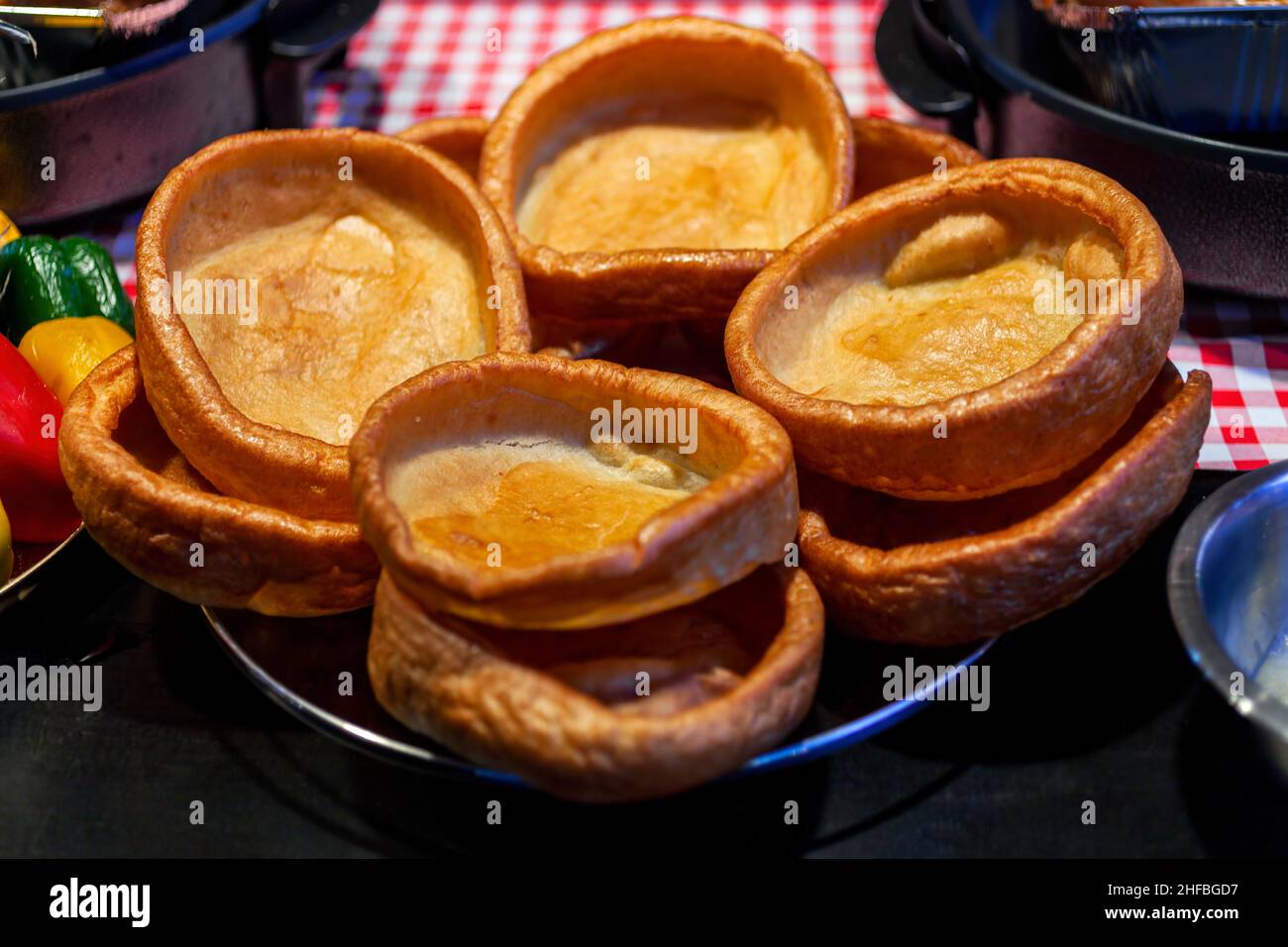 Traditional English Yorkshire pudding freshly baked on a tray ready to ...