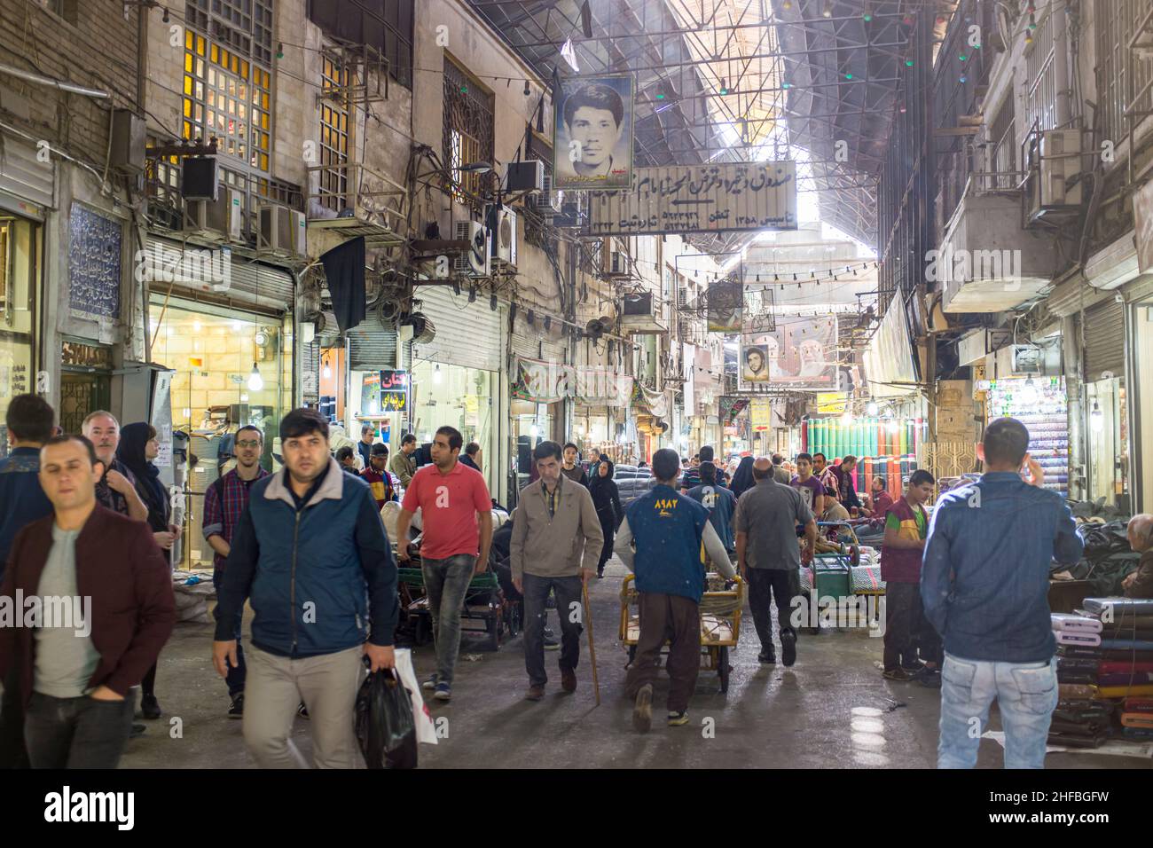 Shoppers and traders walking past market stalls through a busy Grand ...