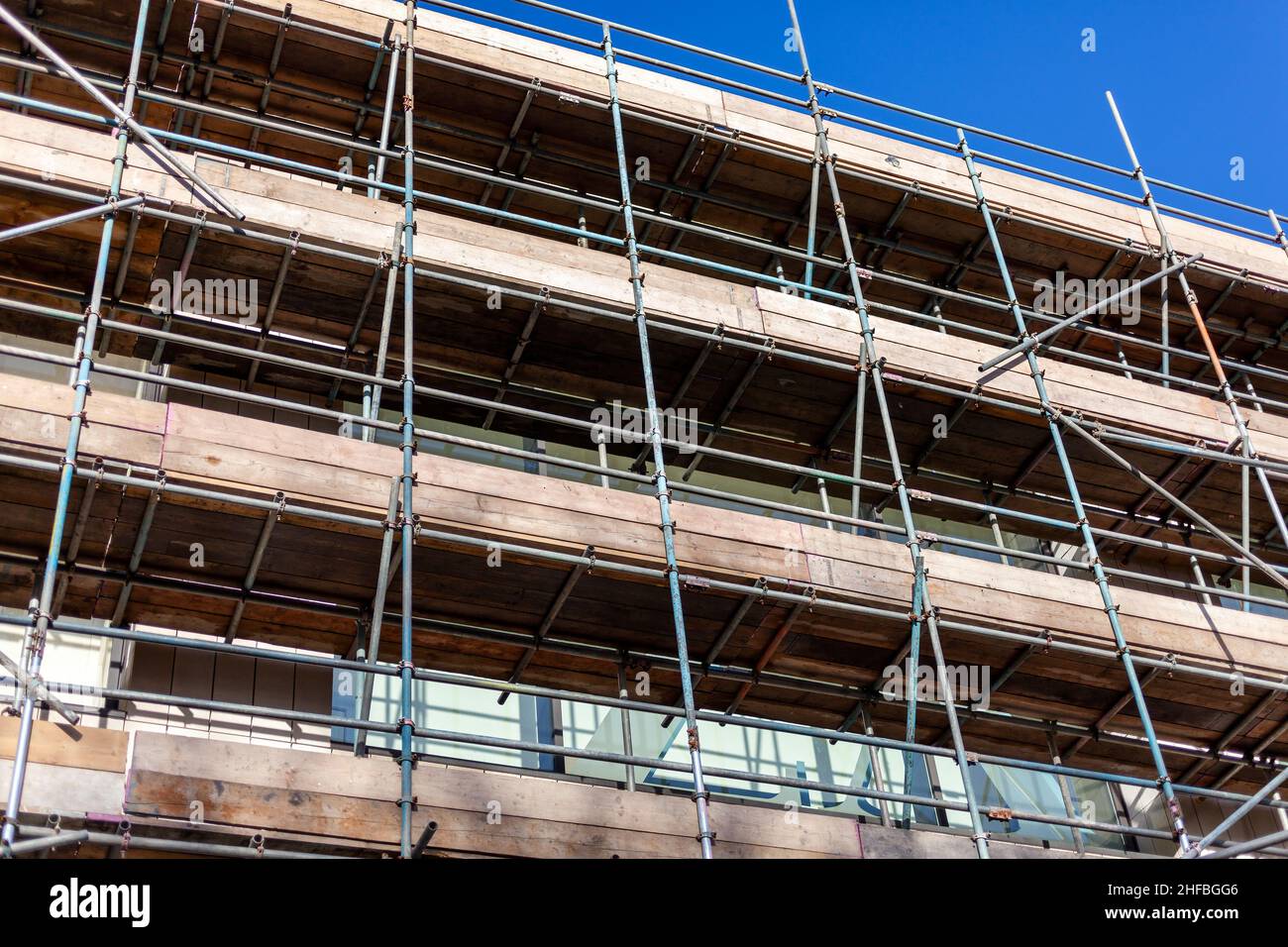 Metal scaffolding building frame with wooden boards platform on an ...