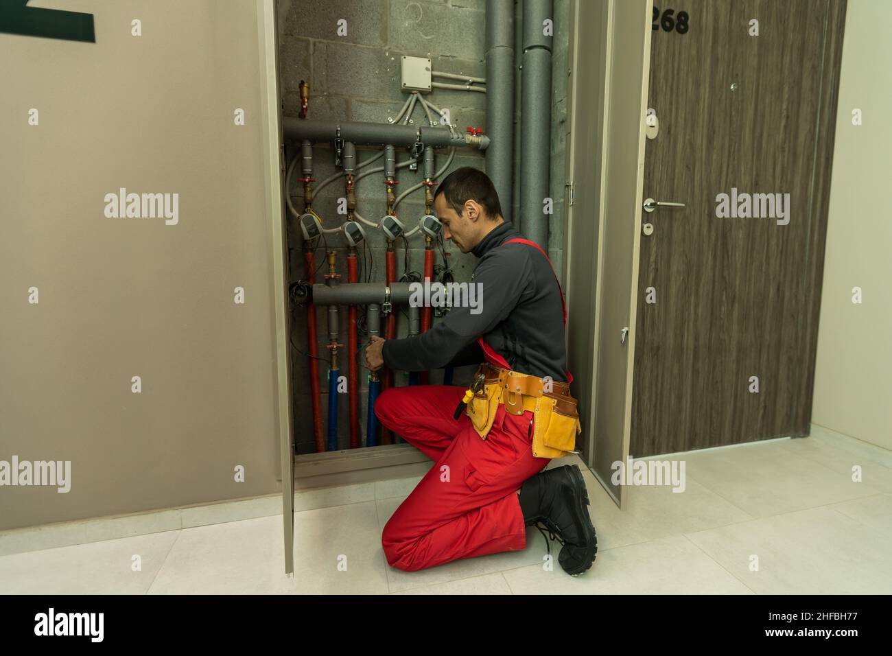 Handyman in uniform fixing pipes hi-res stock photography and images ...