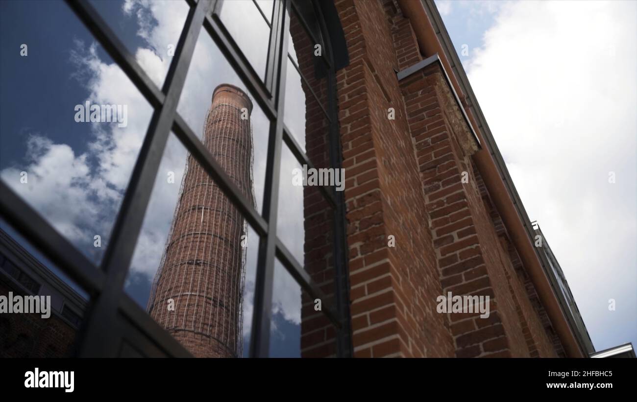 Old chimney of Moscow Arma business quarter reflected in a window ...