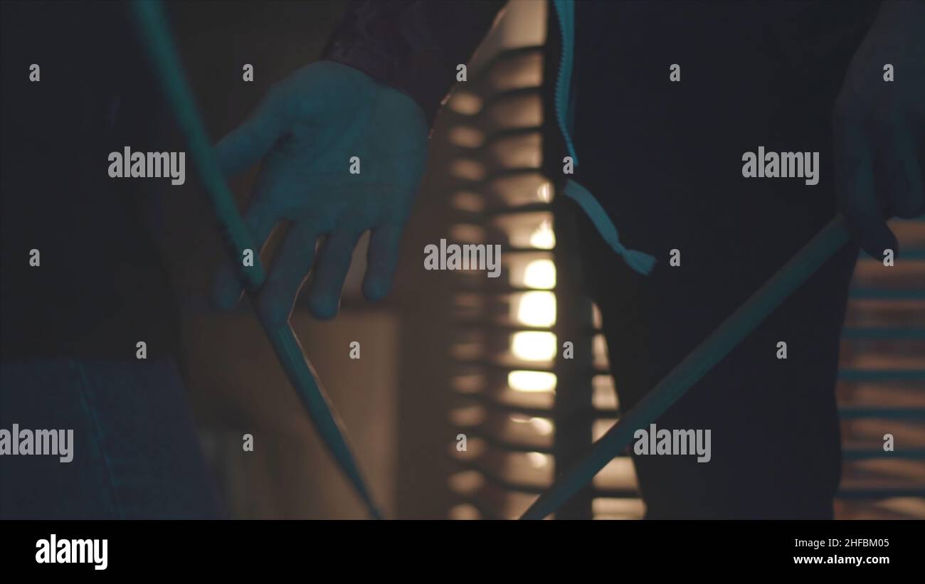 Close up of the man holding drum stick between fingers and spinning it ...