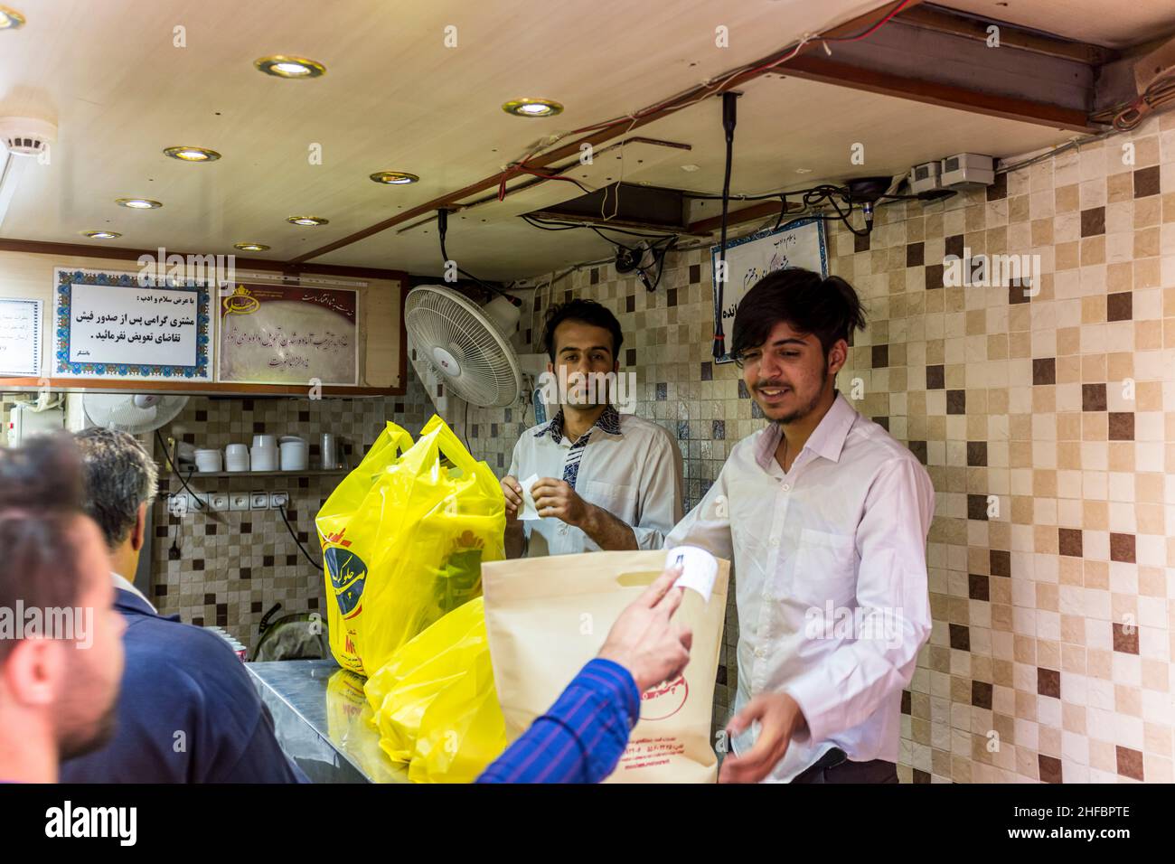Staff members serving takeaway food from the Moslem restaurant in the ...