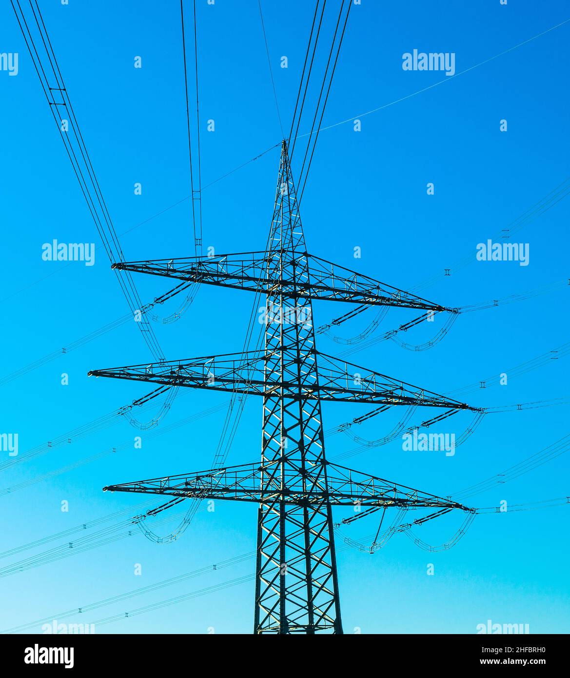 electrical pylon under blue sky, power line cable Stock Photo - Alamy