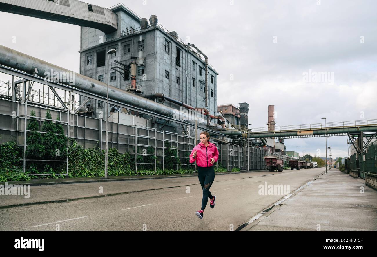 Woman running in an industrial zone Stock Photo - Alamy