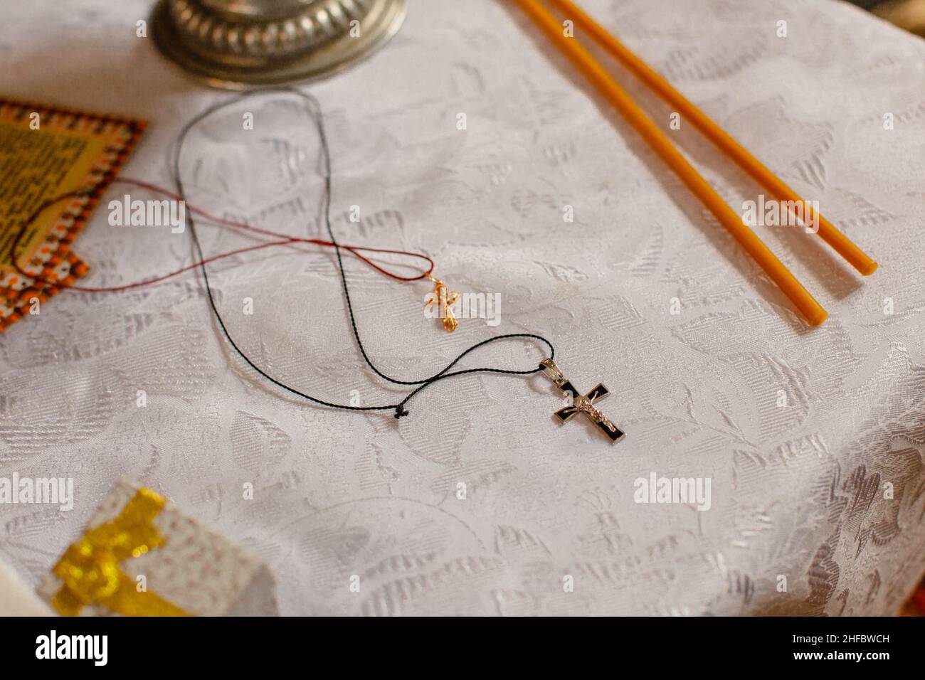 Two crosses and religious candles on the throne in the church. Bowl for ...