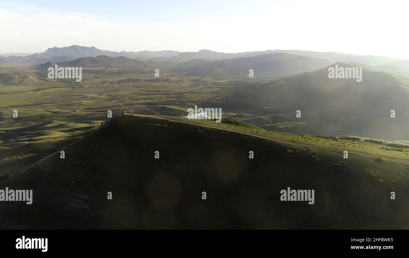 Breathtaking aerial view of the green hill and the valley on blue sky ...