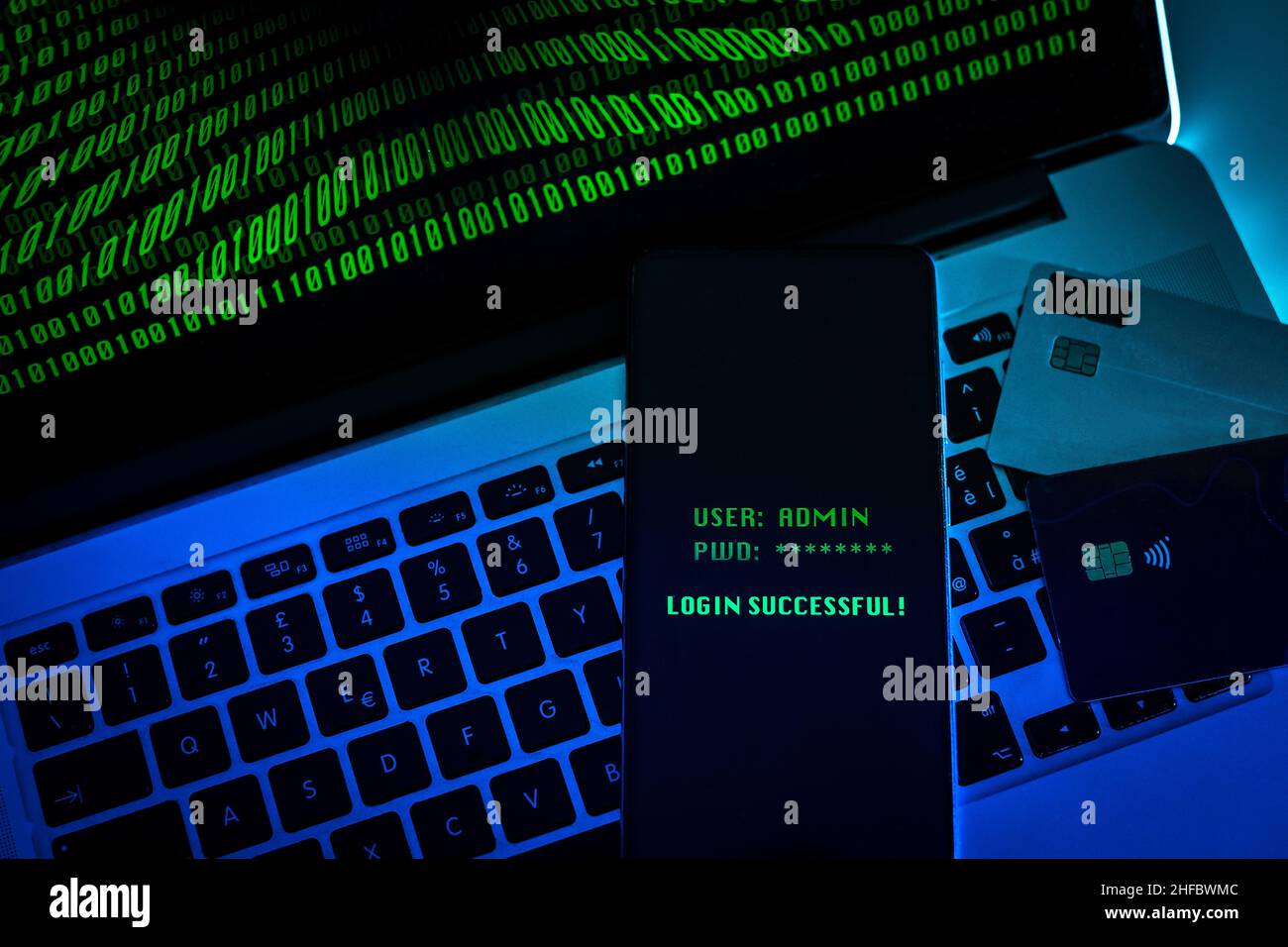 Laptop with green numbers on display. Credit cards, smartphone ...