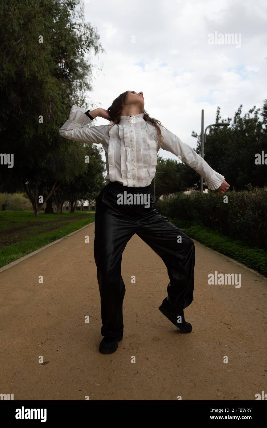 Young woman dancing outdoors. Dance performance in the street Stock ...