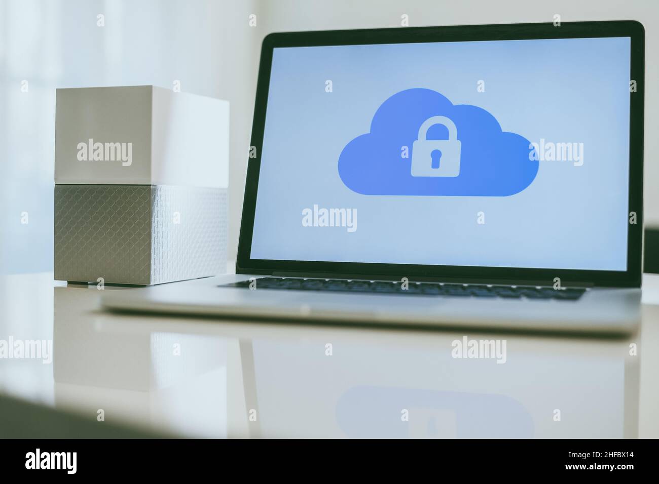 Laptop on the desk with network attached storage. Living room view ...