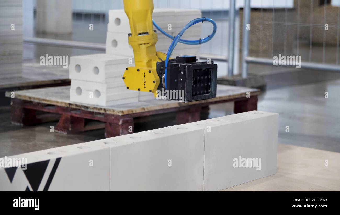 Industrial robot exhibit at work. Bricklayer robot for automated ...