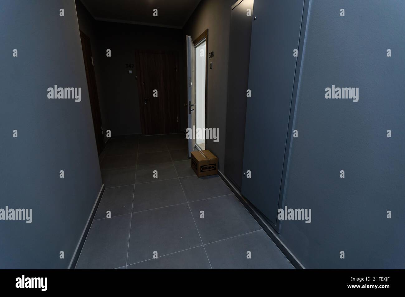 Cardboard boxes on rug near door. Parcel delivery service Stock Photo ...