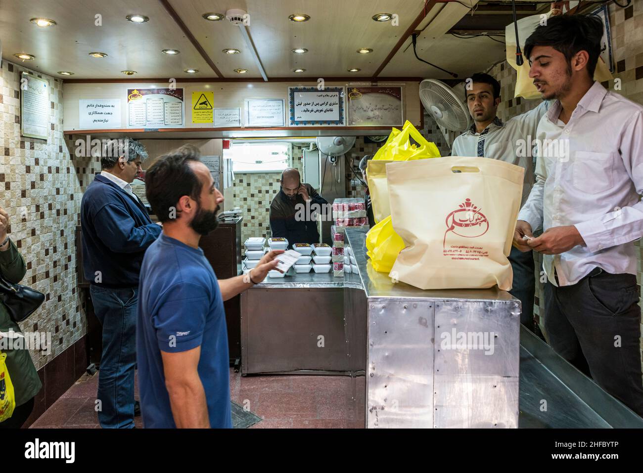 Staff members serving takeaway food from the Moslem restaurant in the ...