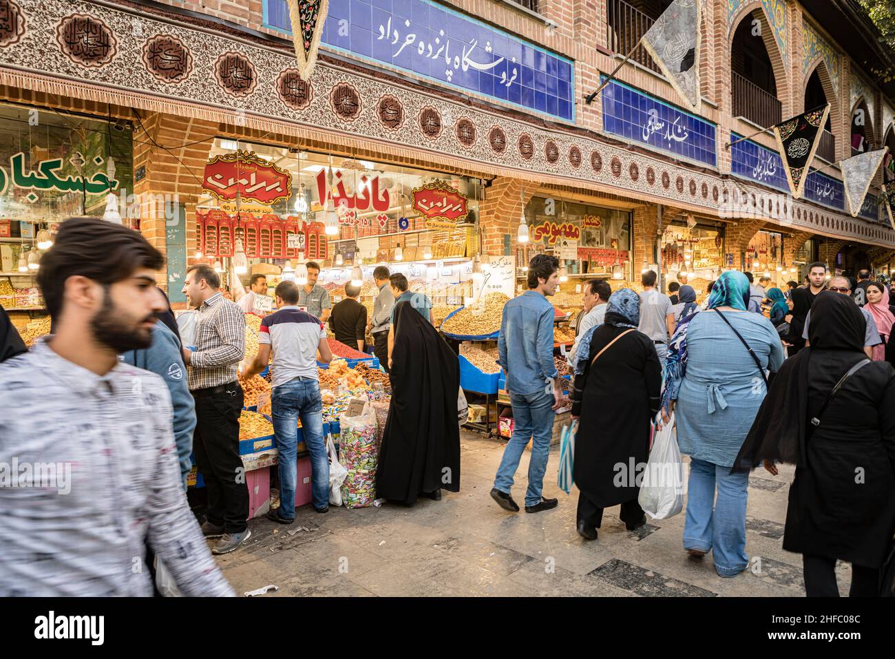 Locals shopping for nuts and dried fruits at the Grand Bazaar in Tehran ...