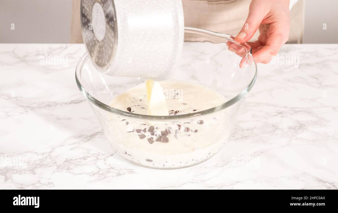 Step by step. Preparing chocolate ganache in a glass mixing bowl Stock ...