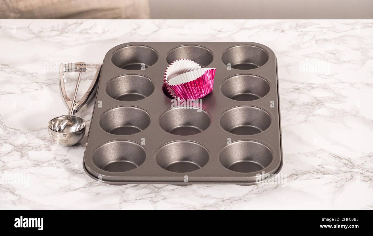 Step by step. Baking chocolate cupcakes. Lining metal cupcake pan with ...