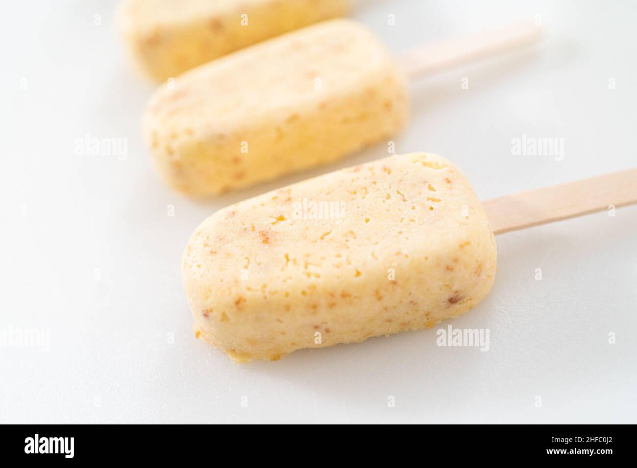 Dipping frozen cakesicles into melted chocolate to prepare mermaid ...