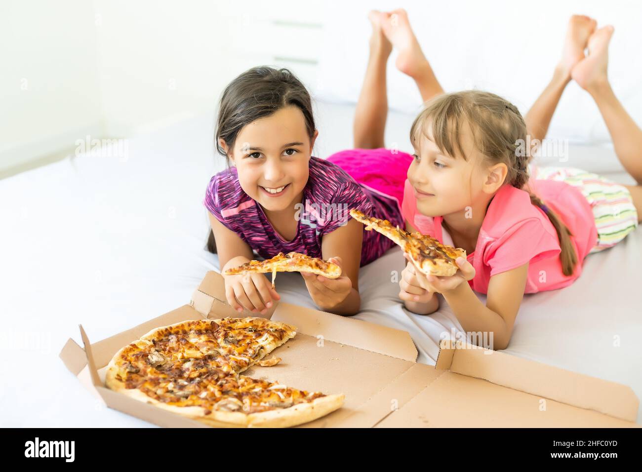 Attractive little girls posing with pizza boxes Stock Photo - Alamy
