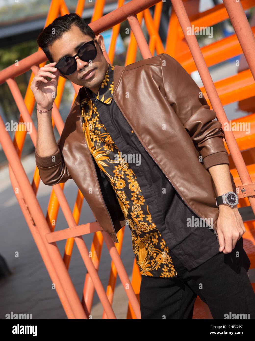 A young male model dressed in Indonesian Batik with Balinese Flower ...