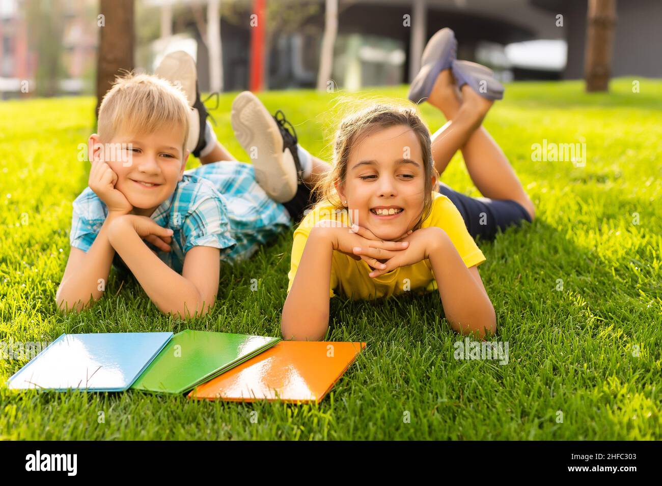 Portrait Of Excited Elementary School Pupils On Playing Field At Break ...