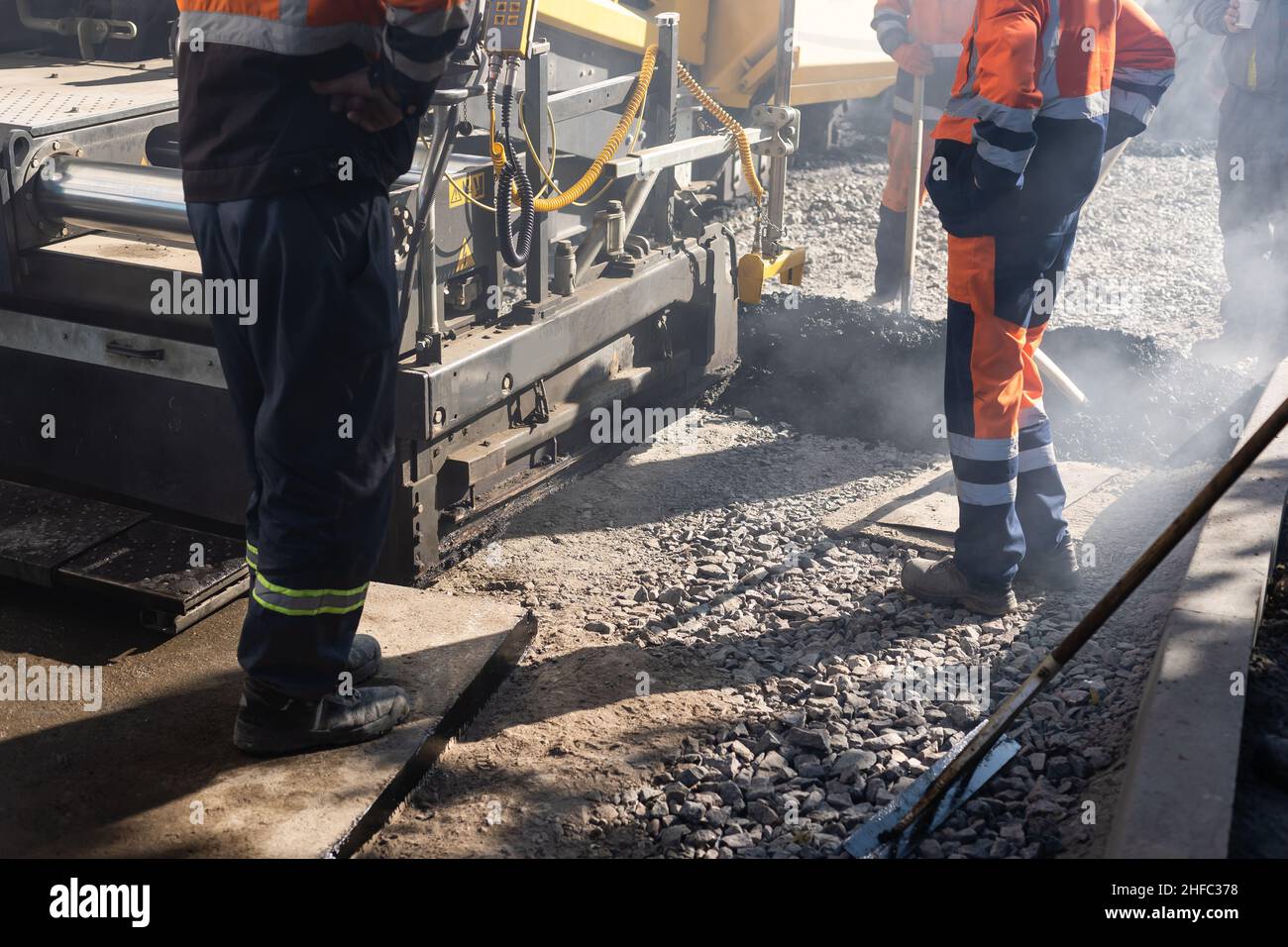 Road construction. Concrete borders. Workers at work Stock Photo - Alamy