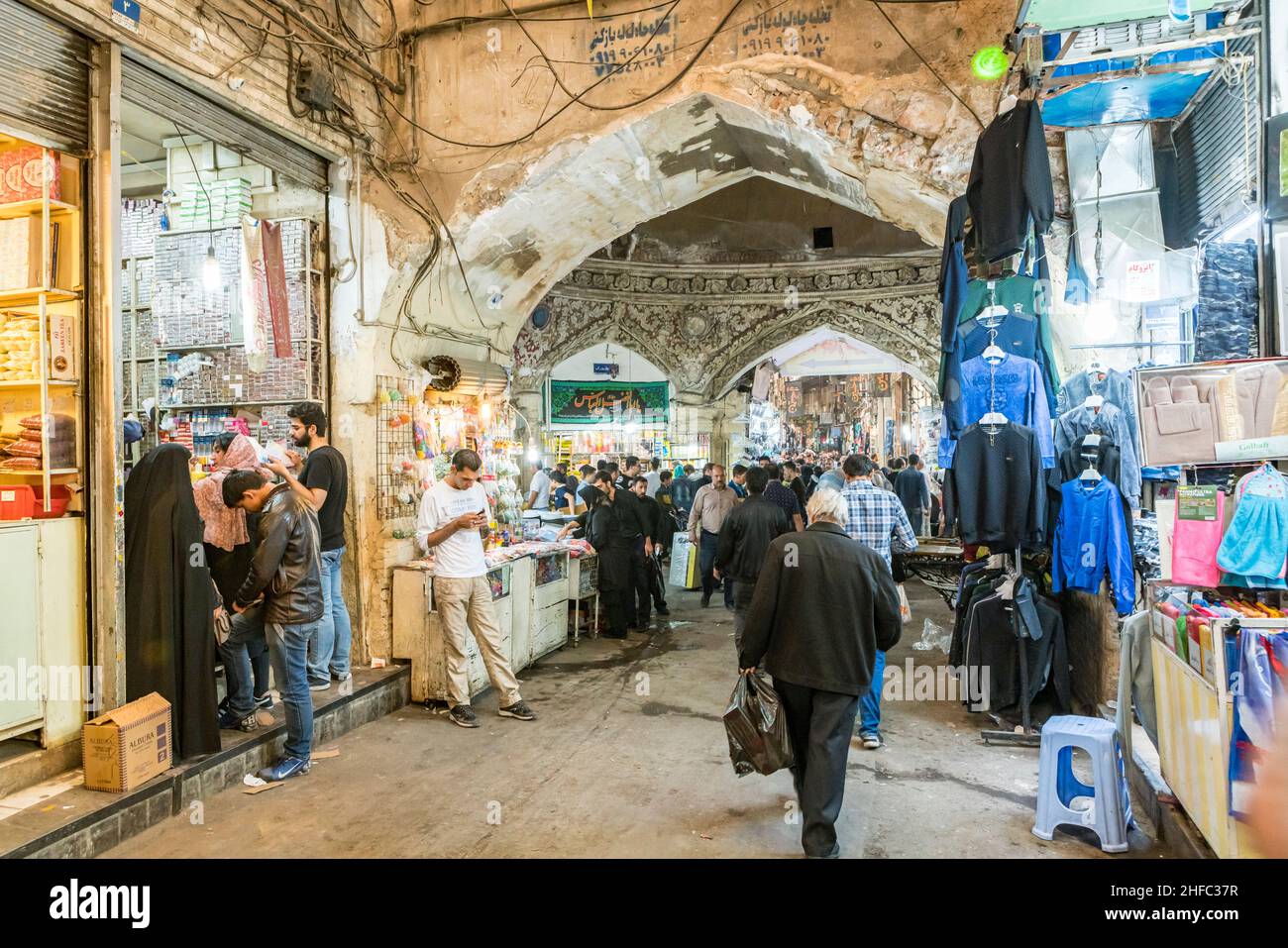 Shoppers and traders walking through a busy Grand Bazaar in Tehran ...